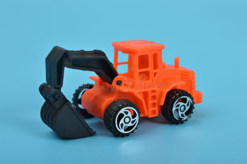 An Orange Backhoe Loader Isolated on a Blue Background Stock Image ...