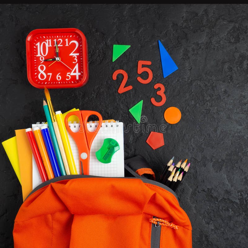 Orange Backpack with School Supplies on a Black Concrete Background ...
