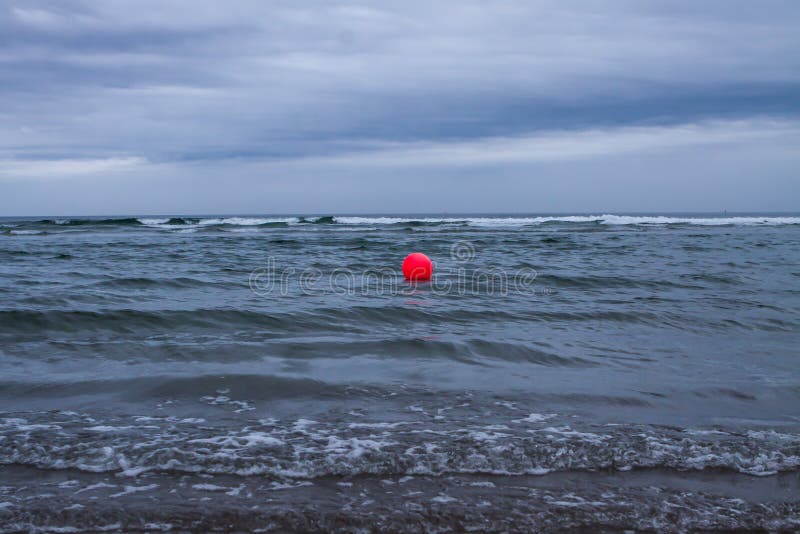 Orange Ball Floating in the Ocean Stock Image - Image of ocean, clouds ...