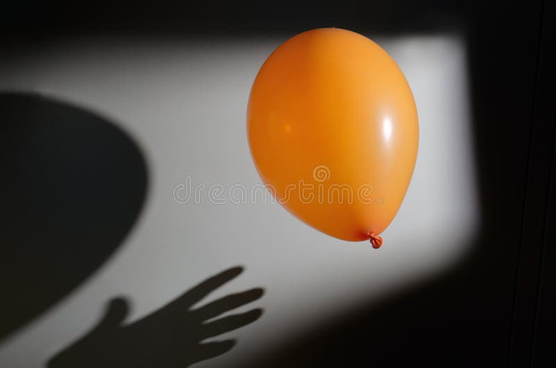 Orange Balloon with Shadow and Hand Shadow Stock Photo - Image of ...