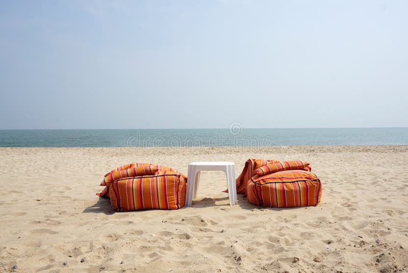 Orange Beach Bed with White Plastic Table on the Beach Stock Image ...