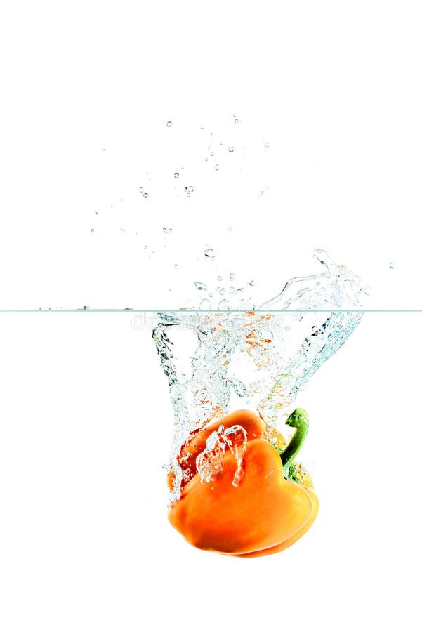Orange Bell Pepper Falling into Water Splash on a White Background ...