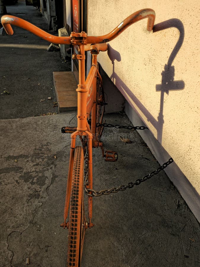Orange bicycle in chains stock photo. Image of bicycle - 287204654