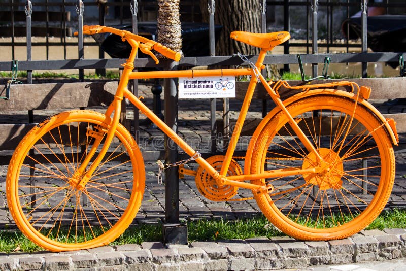 An Old Orange Bicycle is Standing on the Sand Path Locked To a Tree ...