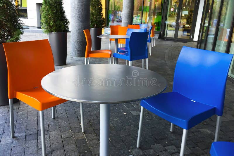 Orange and Blue Chairs and Round Tables in Outdoor Cafe Stock Image ...