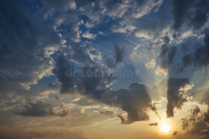 Orange and Blue Sky with a Setting Sun Behind a Clouds Stock Image ...