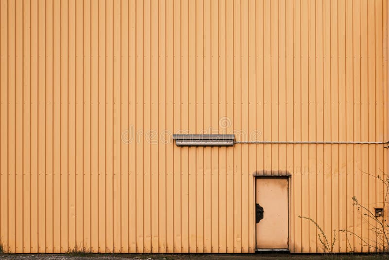 Orange Building Wall with a Weathered Door Stock Photo - Image of door ...