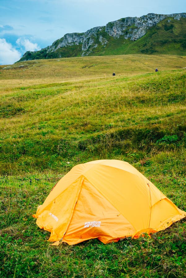 Orange Camping Tent with Backpack in the Cozy Green Forest Editorial ...