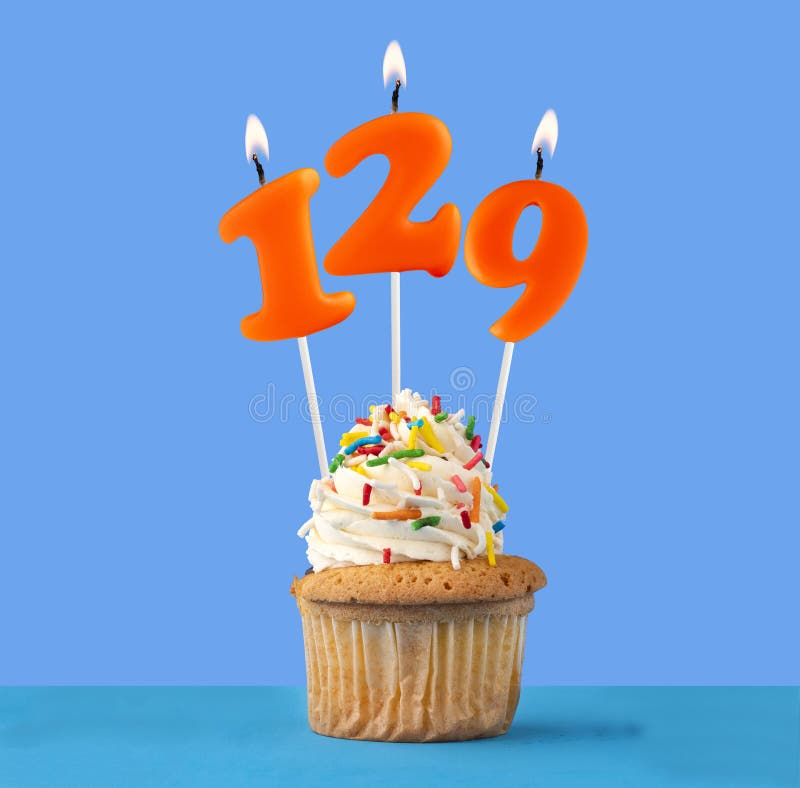 Orange Candle Number 129 - Birthday Cupcake on Blue Background Stock ...