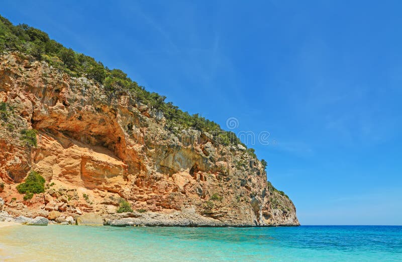 Orange cliff by the sea stock photo. Image of sardinia - 42329862