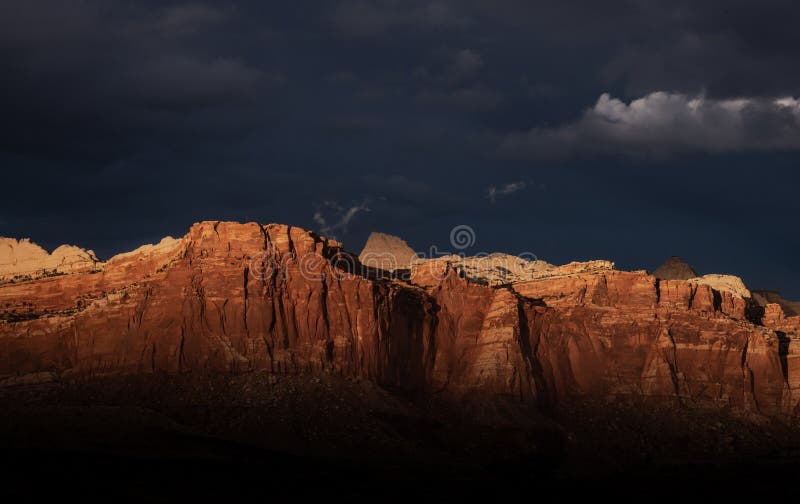 Orange Cliffs and Dramatic Clouds on Dark Skies Stock Photo - Image of ...