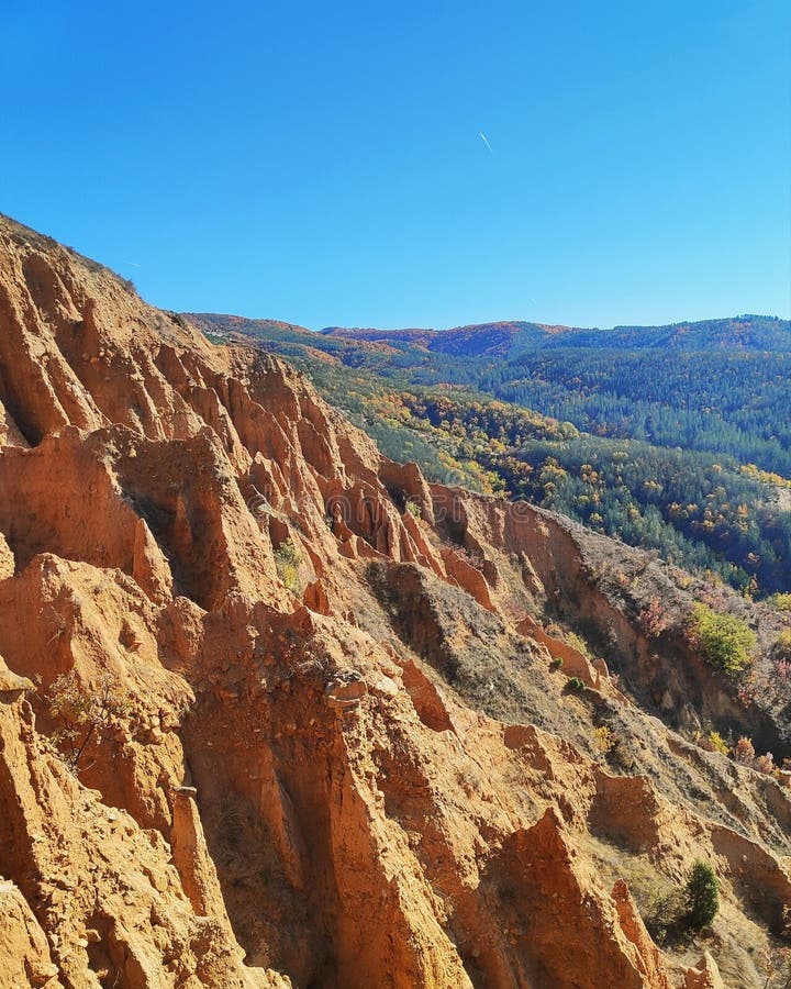 Orange Cliffs with Vegetation and Rocks on a Mountainside: Stob ...
