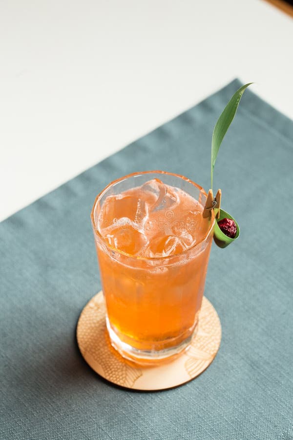 Orange Cocktail with Ice Cubes on the Table at Restaurant Stock Photo ...