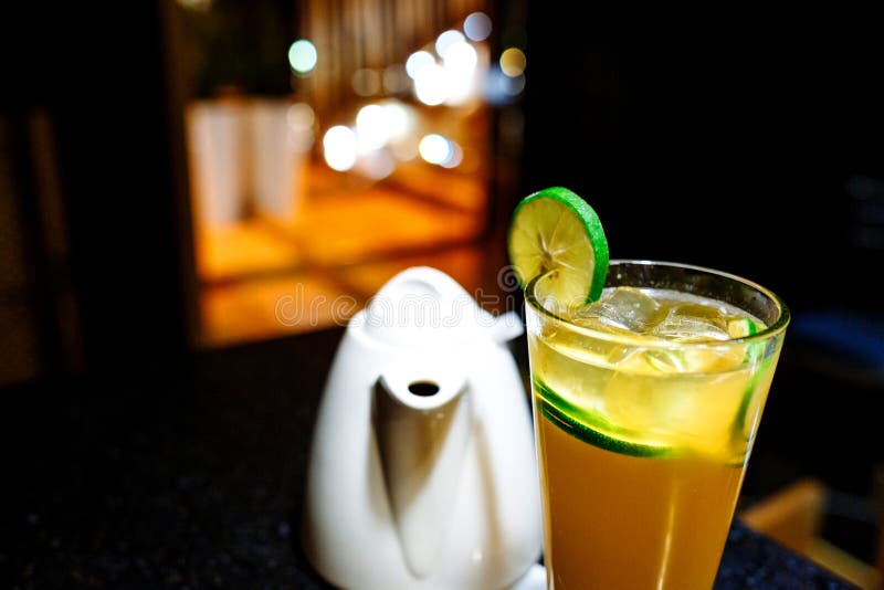 Orange Cocktail with Lime and Teapot on Dark Background Stock Image ...