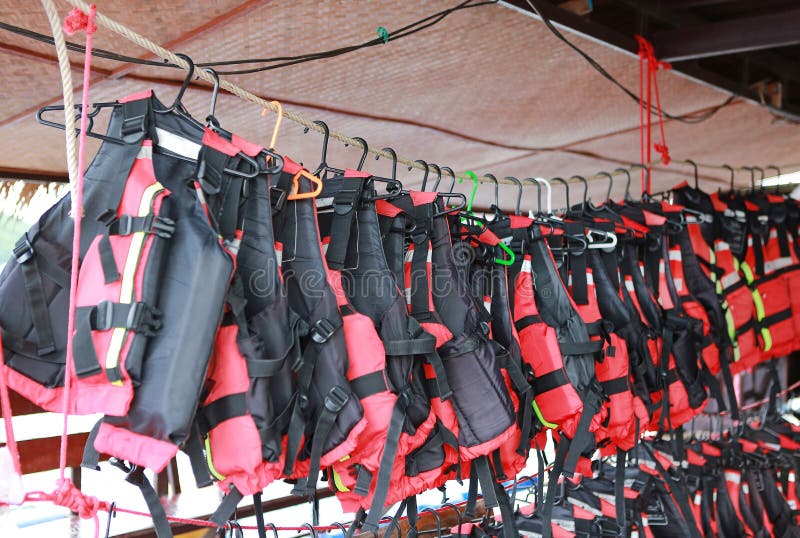 Orange Color Life Jackets Hanging in the Row on Boat Station Stock ...