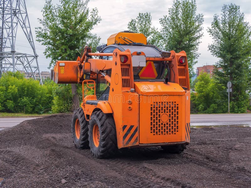 Orange Color Skid Steer Loader with a Many Purpose Bucket is Using in ...