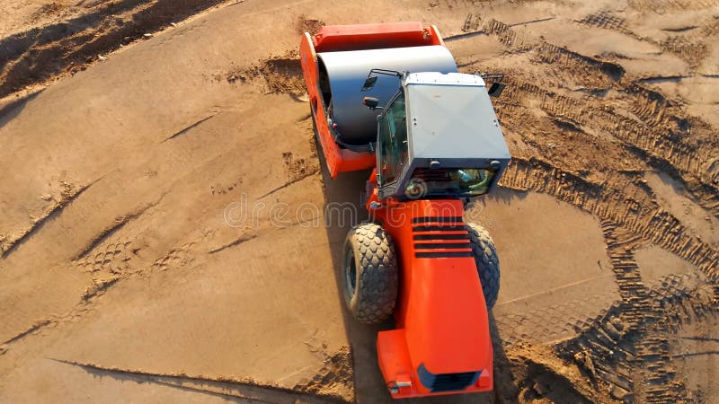 Orange compactor machinery stock image. Image of pavement - 111992859