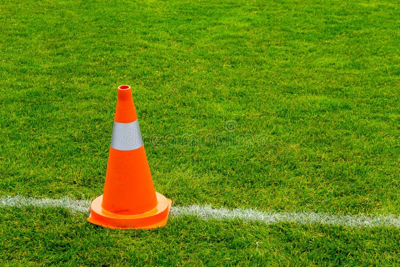 Orange cone on grass field stock image. Image of touchdown - 35131529