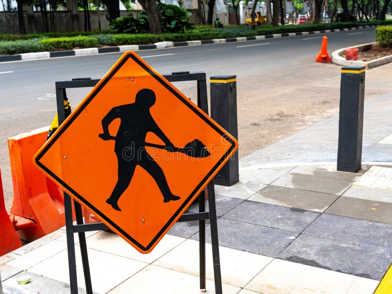 An Orange Construction Traffic Sign on a Sidewalk Stock Photo - Image ...