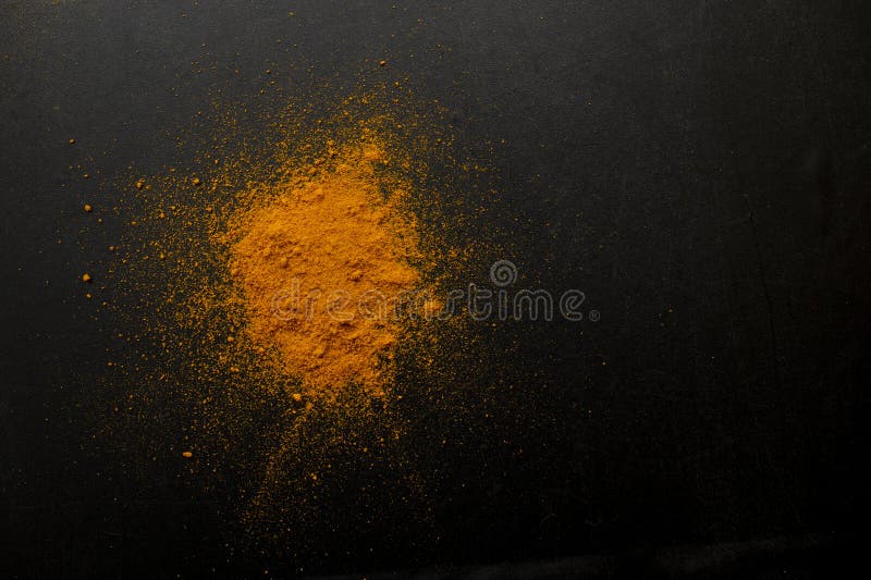 Orange Curry Powder Explosion on Black Texture, Soft Focus Stock Image ...