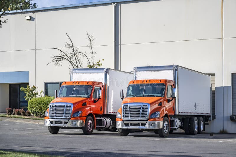 Orange Day Cab Middle Duty Rigs Semi Trucks with Box Trailers Standing ...