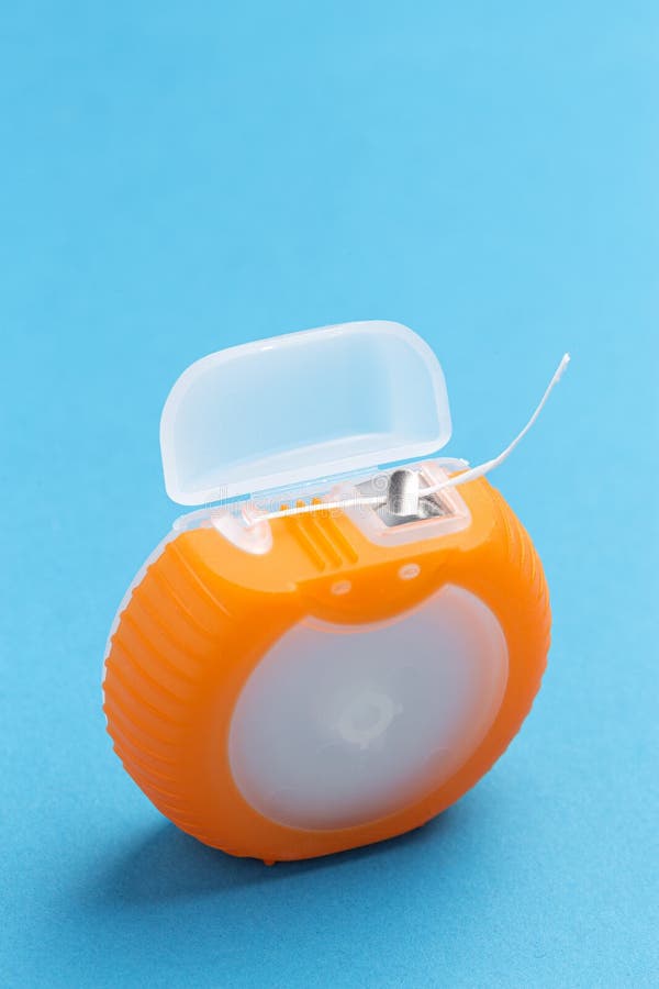 Orange Dental Floss Box on Blue Background Stock Image - Image of floss ...