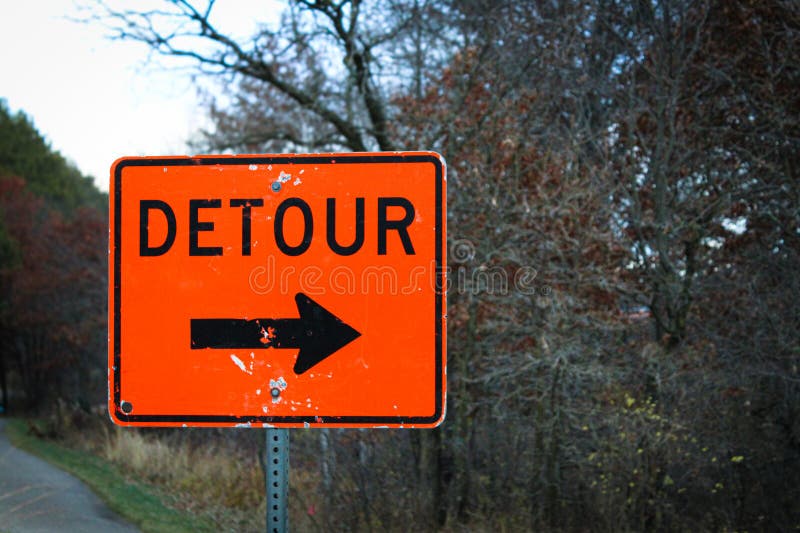 Orange Detour Sign in a Park Setting Background with Black Arrow ...