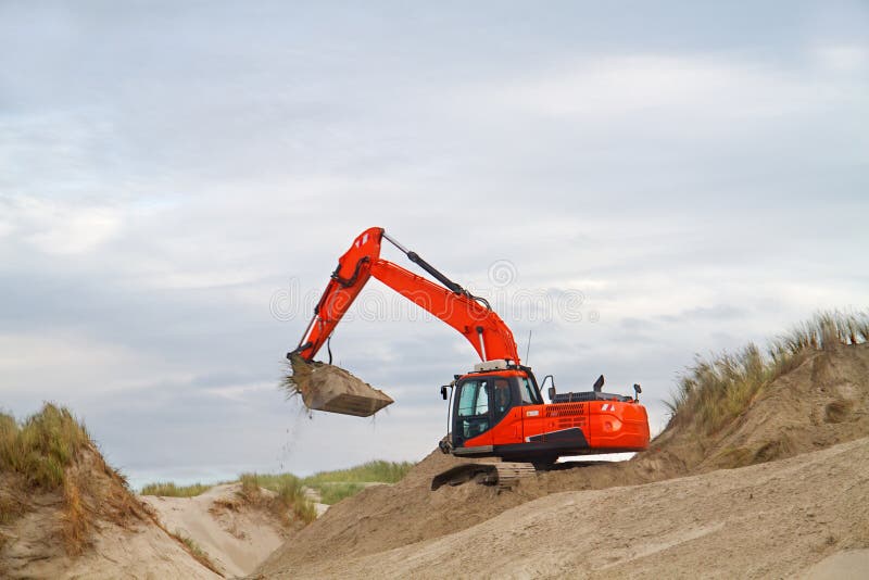 An Orange Digger with a Backhoe Working on a Large Urban Demolition ...