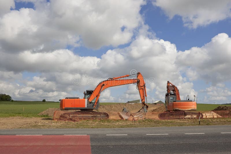 Orange diggers stock image. Image of landscape, excavators - 19392691