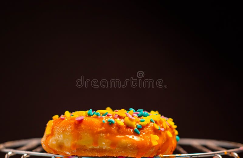 Orange Donuts with Shavings of Many Colors Stock Photo - Image of ...