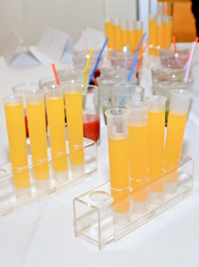 Orange Drink in Test Tubes with Focus on the First Tube from the Front ...