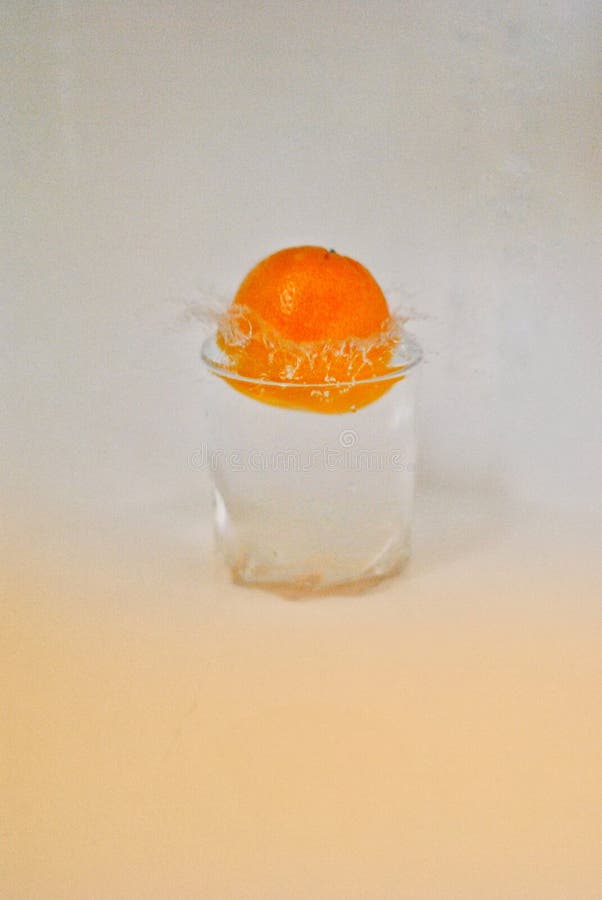 Orange Dropping into a Cup of Water Stock Image - Image of colour ...