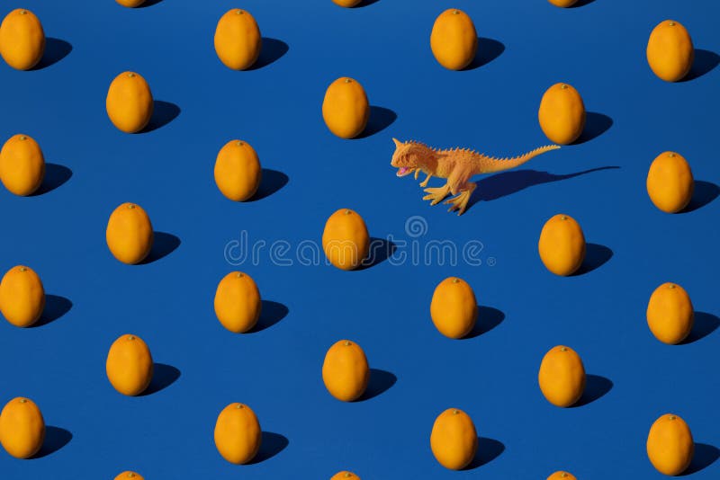 Orange Egg with Dinosaur on a Blue Background. Pattern Stock Photo ...