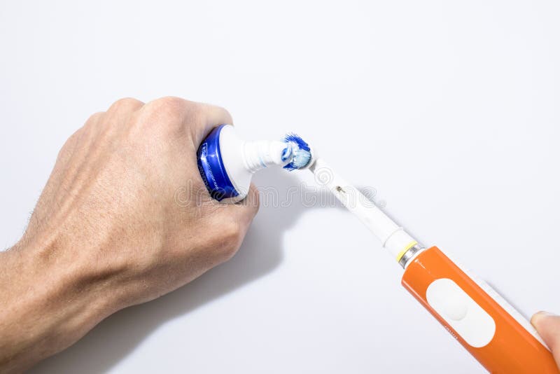 Orange Electric Toothbrush and Toothpaste in a White Ba Stock Photo ...