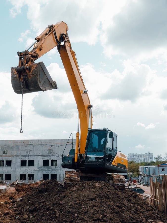 Orange Excavator Digs Soil on Construction Site Stock Photo - Image of ...