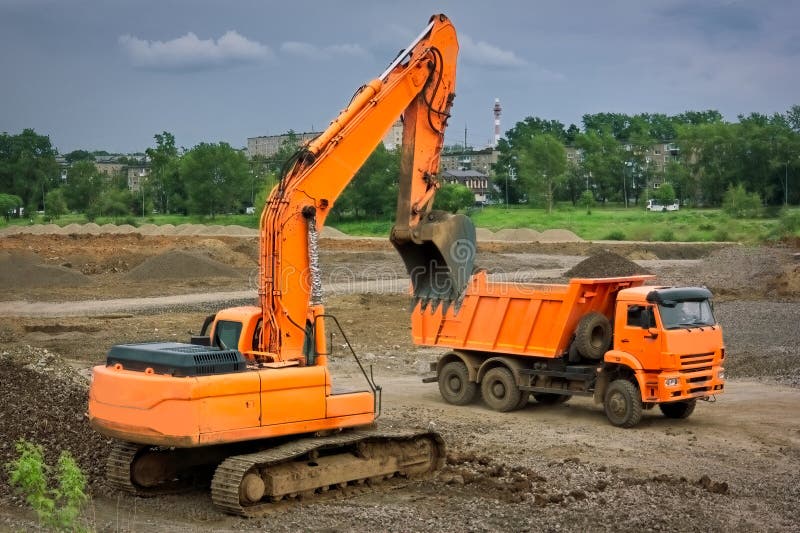 Orange Excavator and Orange Dump Truck at a Construction Site Stock ...