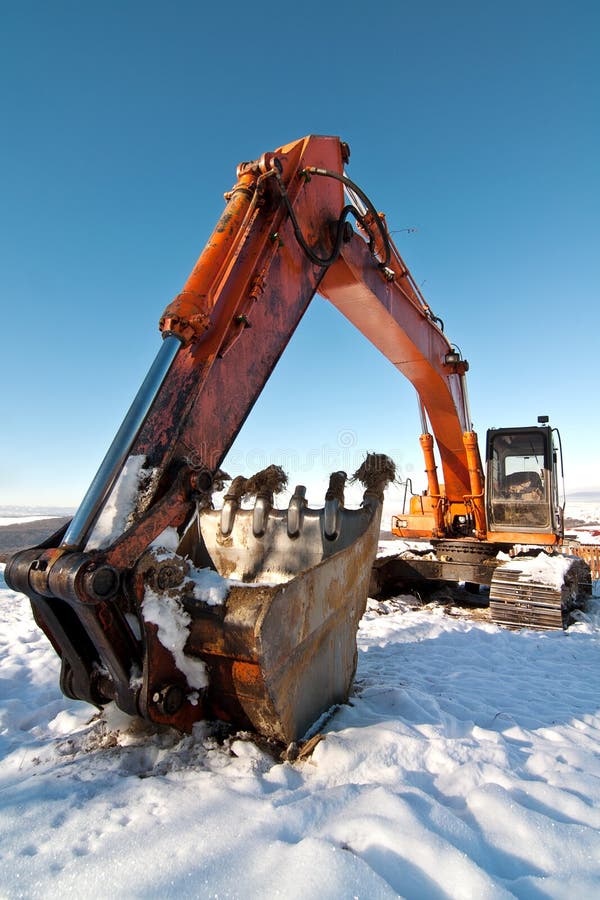 Orange excavator in snow stock image. Image of work, winter - 18234279