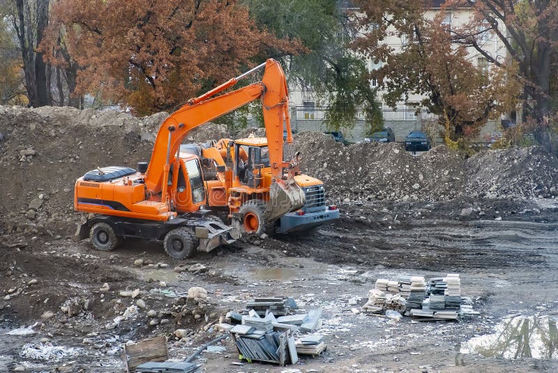 Orange Excavator and Wheel Loader in a Construction Site Stock Image ...