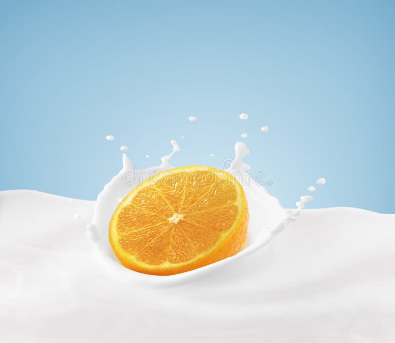 Orange Falling into a Splash of Milk Isolated on Blue Background Stock ...