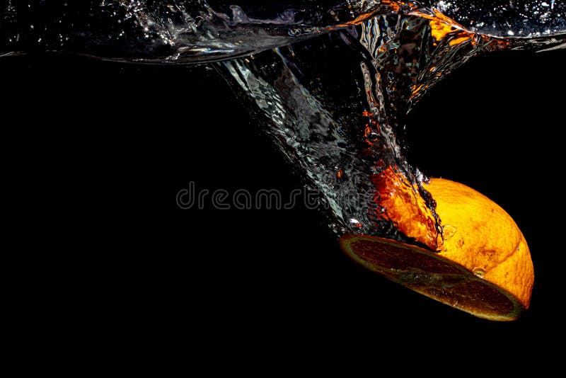 Orange Falling into Water, Clash Fruit with Water on Black Background ...