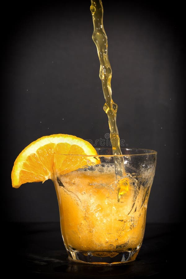 Orange Flavoured Soft Drink Splashing Over the Glass. Stock Photo ...