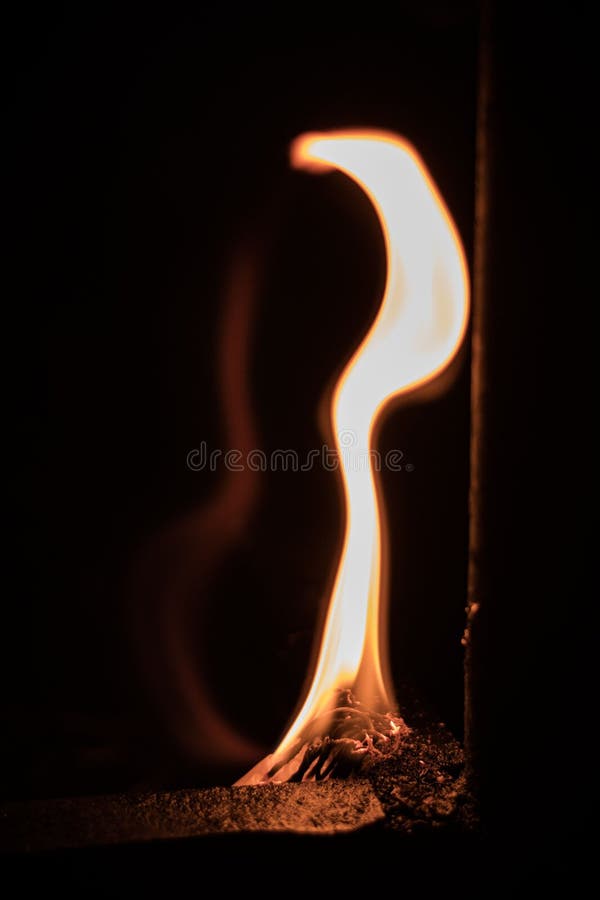 Orange, Flickering Fire is Burning Inside a Glass Bottle, Emitting a ...