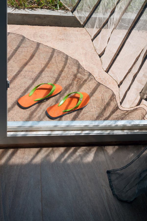 Orange Flip-flops Lying at a House Entry Stock Image - Image of leaning ...