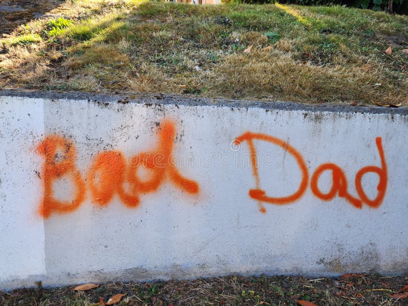 Orange Graffiti on a Cement Wall that Says Bad Dad Stock Image - Image ...