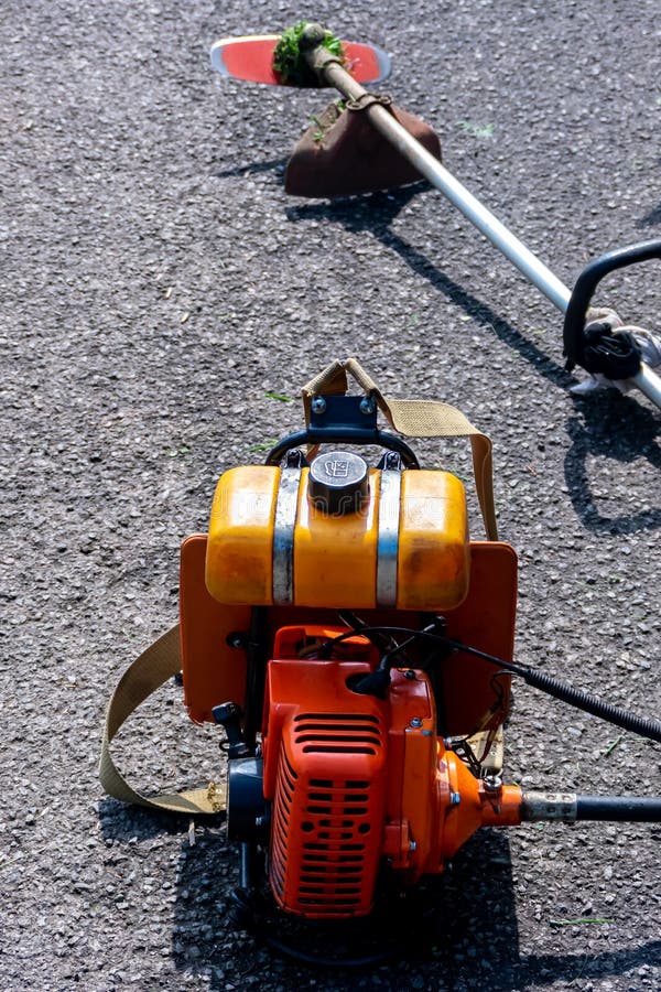 Orange Grass Cutter or Trimmer Machine Under the Sunlight Editorial ...