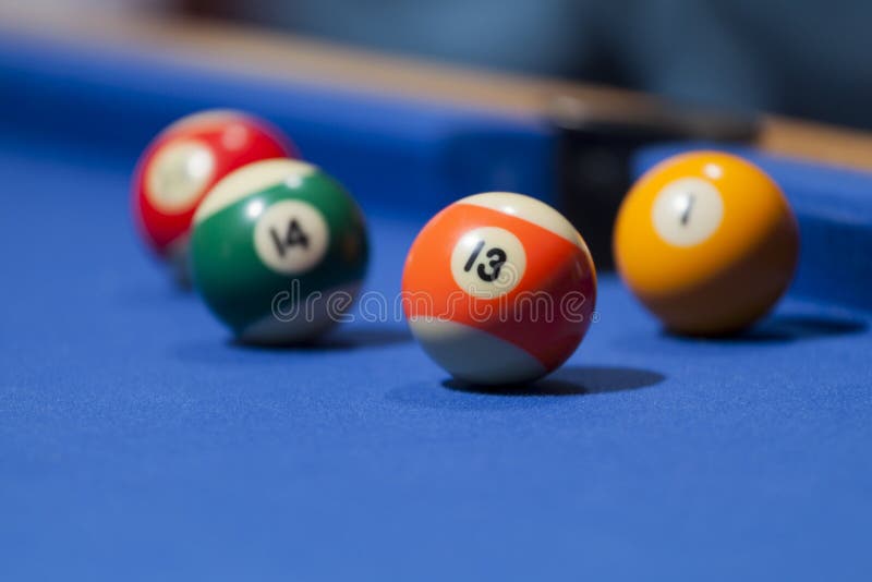 Orange, Green, Yellow and Red Billiard Balls in a Pool Table Stock ...