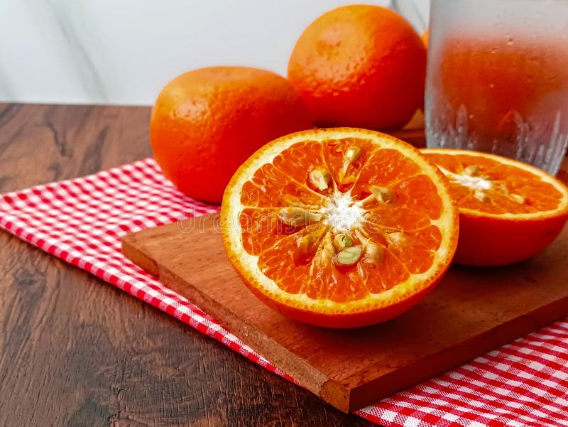 Orange Halves on a Background of Whole Oranges and a Glass of Water ...