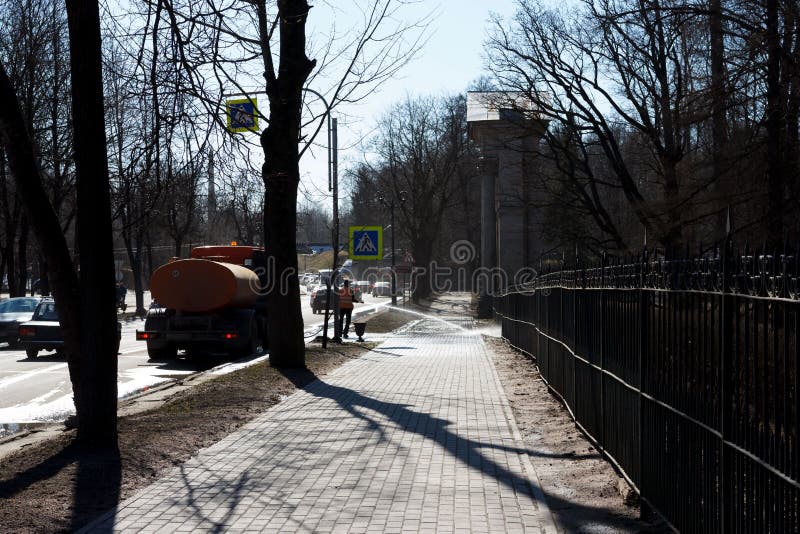Orange Harvesting Machine and Worker Washes Road in Spring. Reportage ...