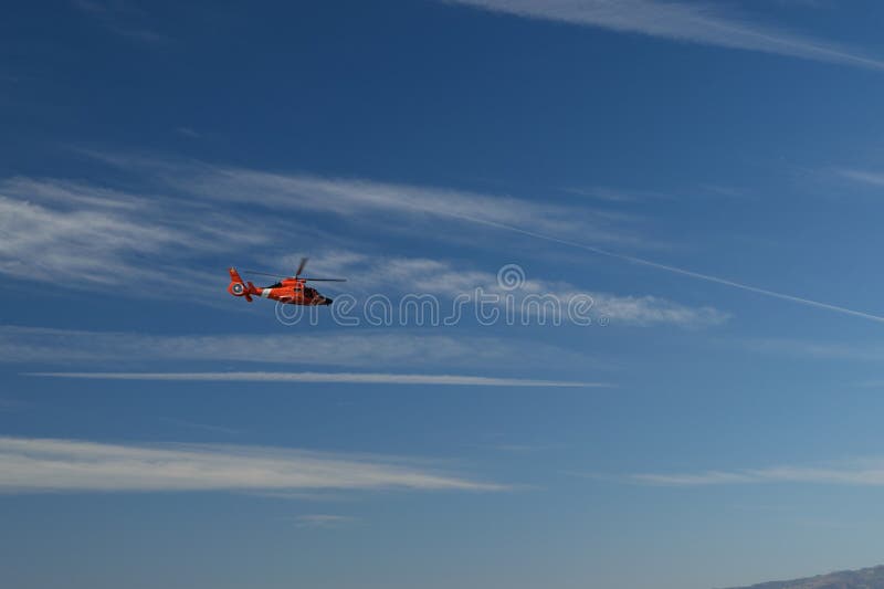 Orange Helicopter Flying in Clear Blue Sky Stock Photo - Image of ...
