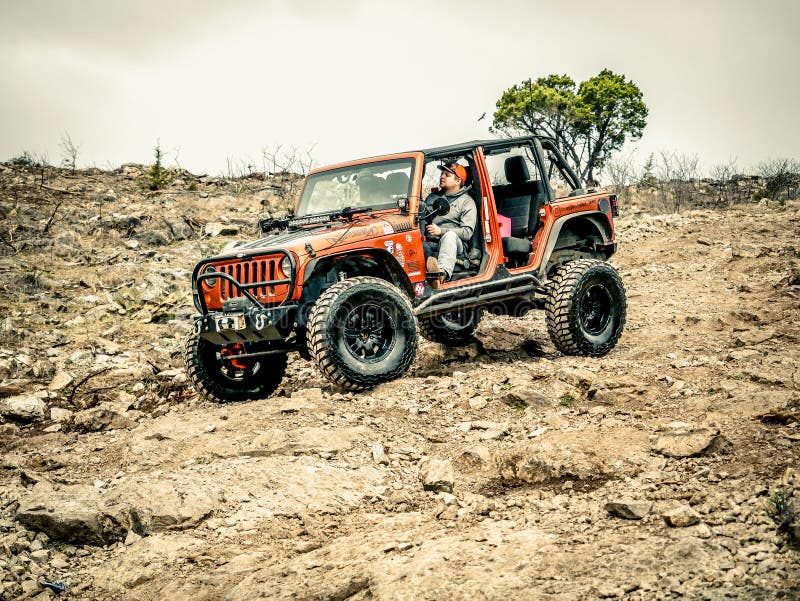 Orange Jeep Rock Crawling editorial stock photo. Image of burnt - 143023843